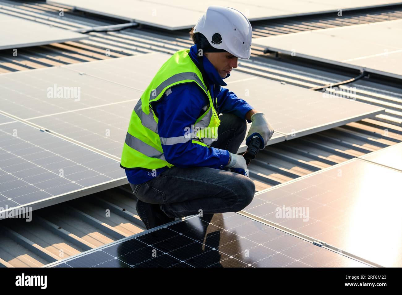 Maintenance technicians installing solar panels at solar cell farm ...