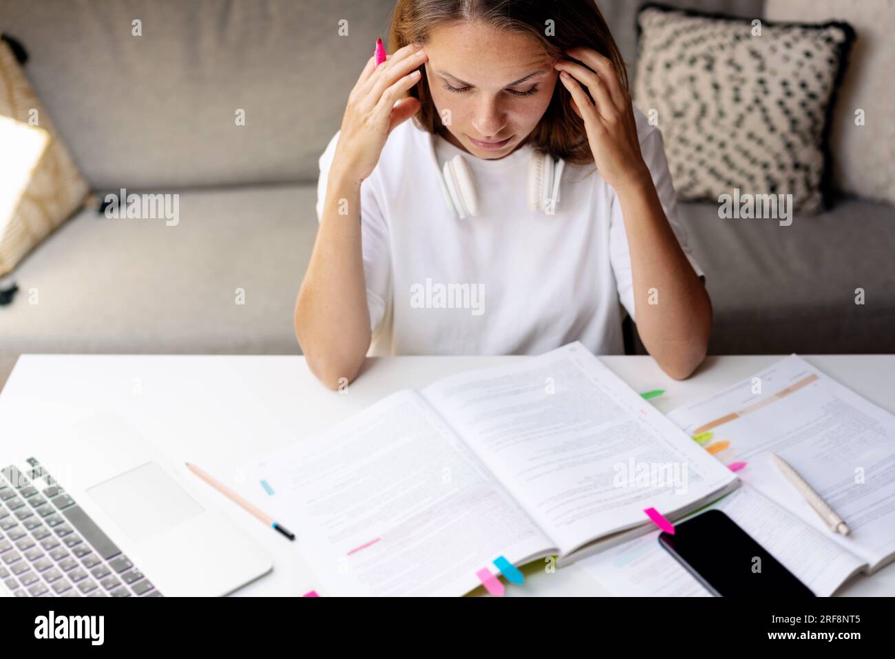 Student young brunette woman doing homework, thinking about exercise in ...