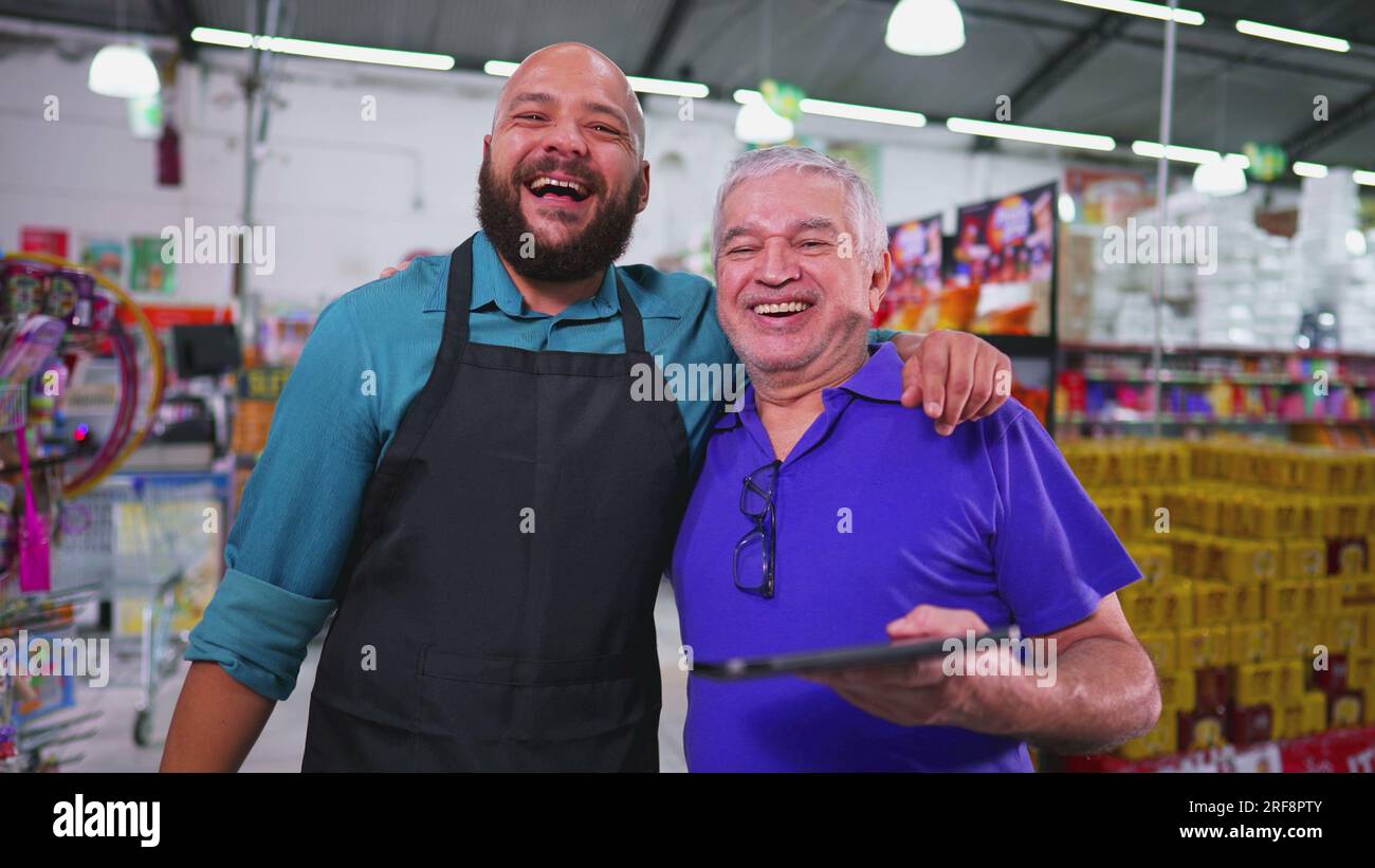 Two employees of Grocery store posing for camera, Brazilian workforce ...