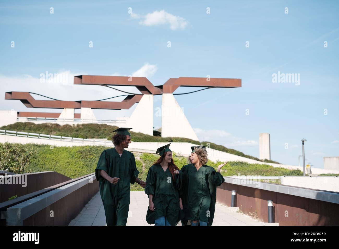 Group of recently graduated university students walking around the ...