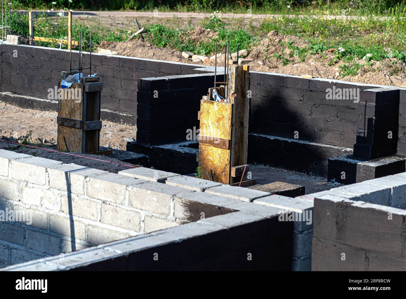 Footings made of concrete blocks painted with black dispersion asphalt ...