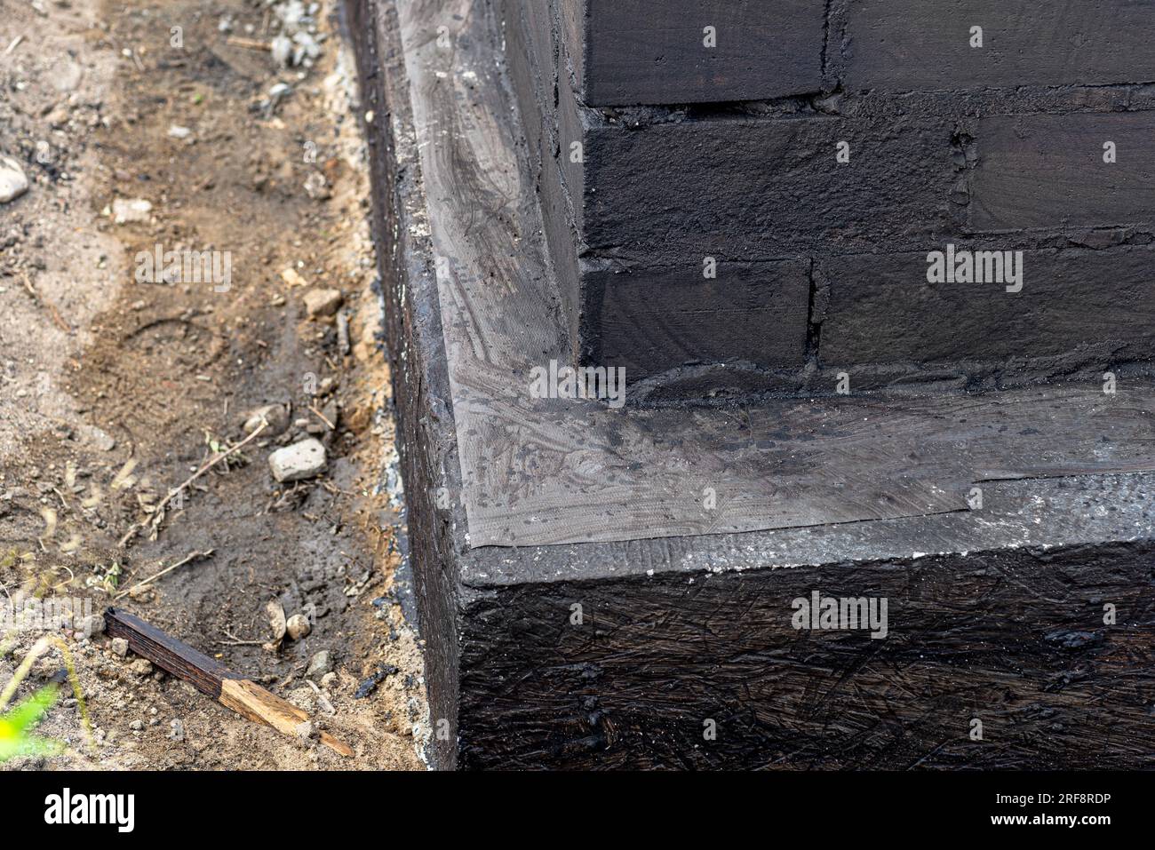 Footings made of concrete blocks painted with black dispersion asphalt ...