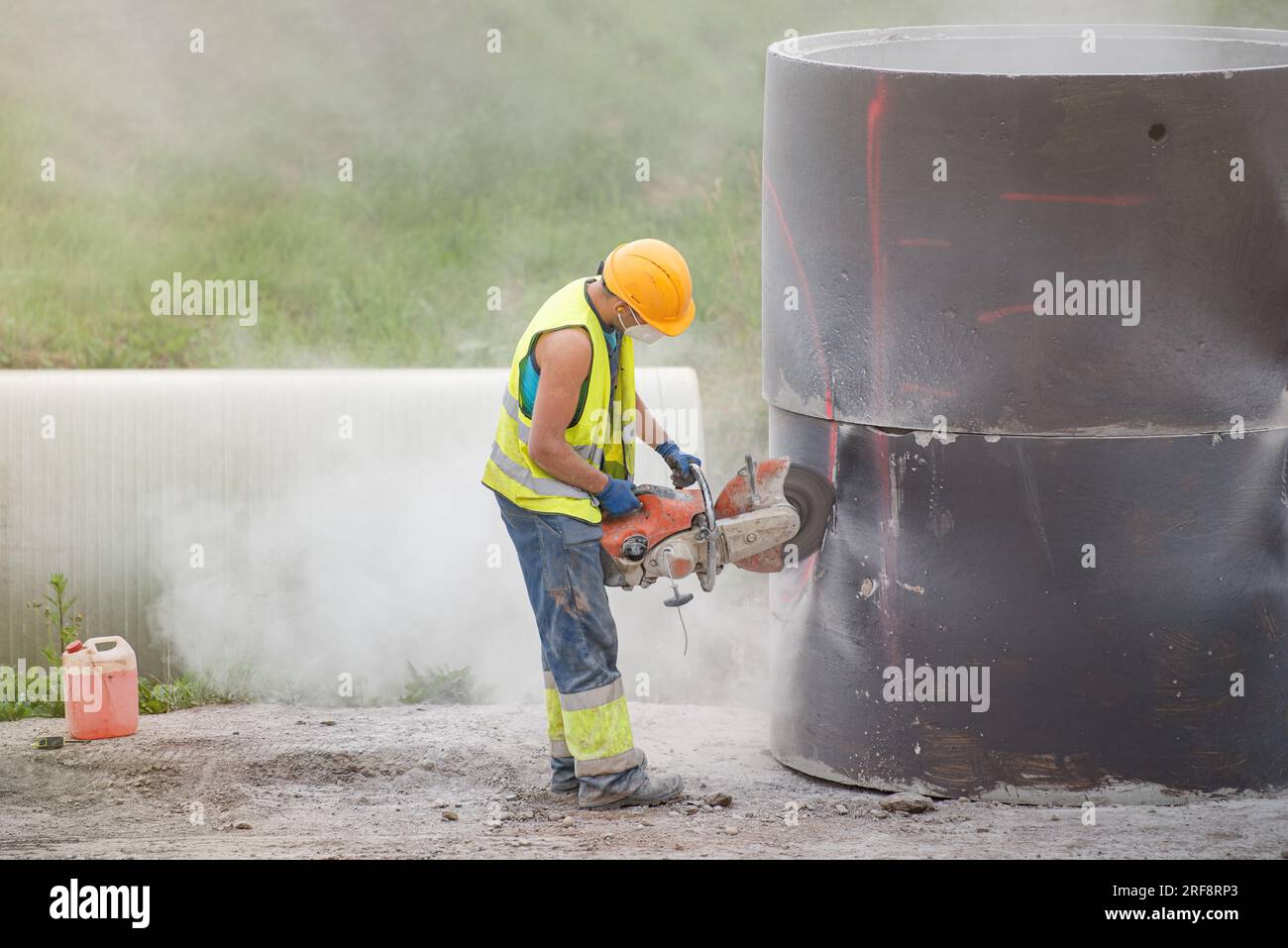 Installing a concrete pipe in the ground to collect rainwater. The ...