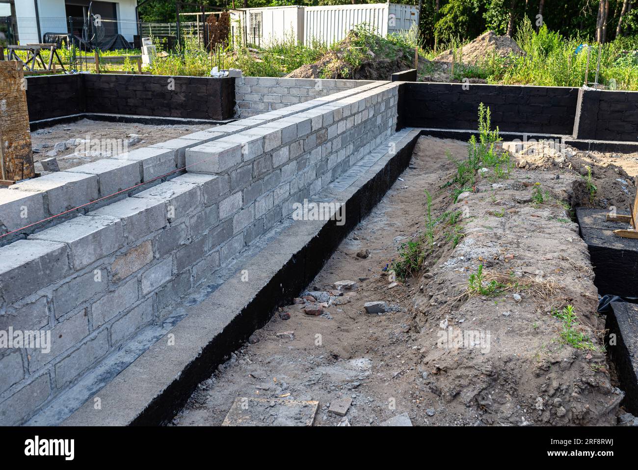 Footings made of concrete blocks painted with black dispersion asphalt ...