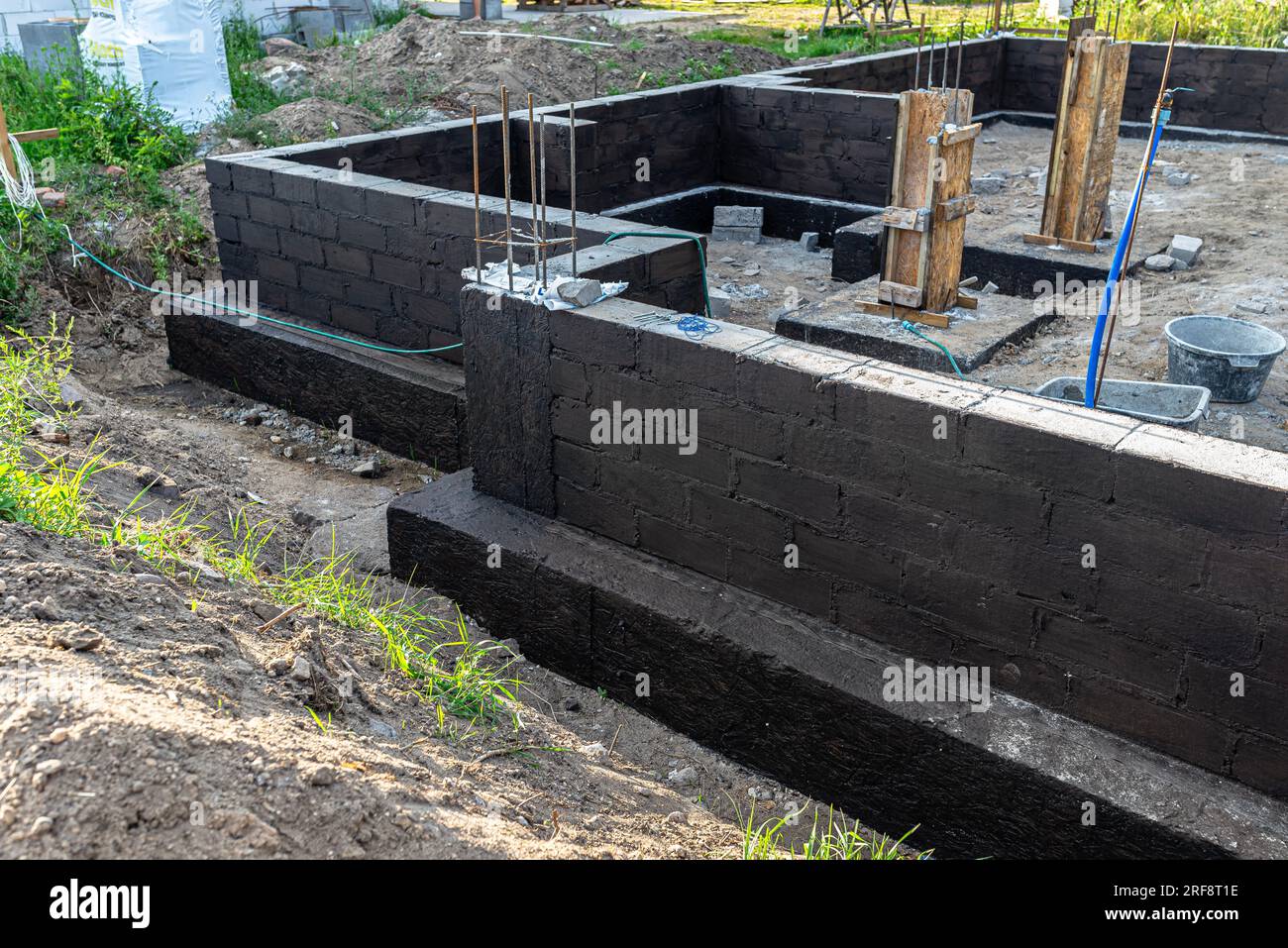 Footings made of concrete blocks painted with black dispersion asphalt-rubber mass, reinforced ...