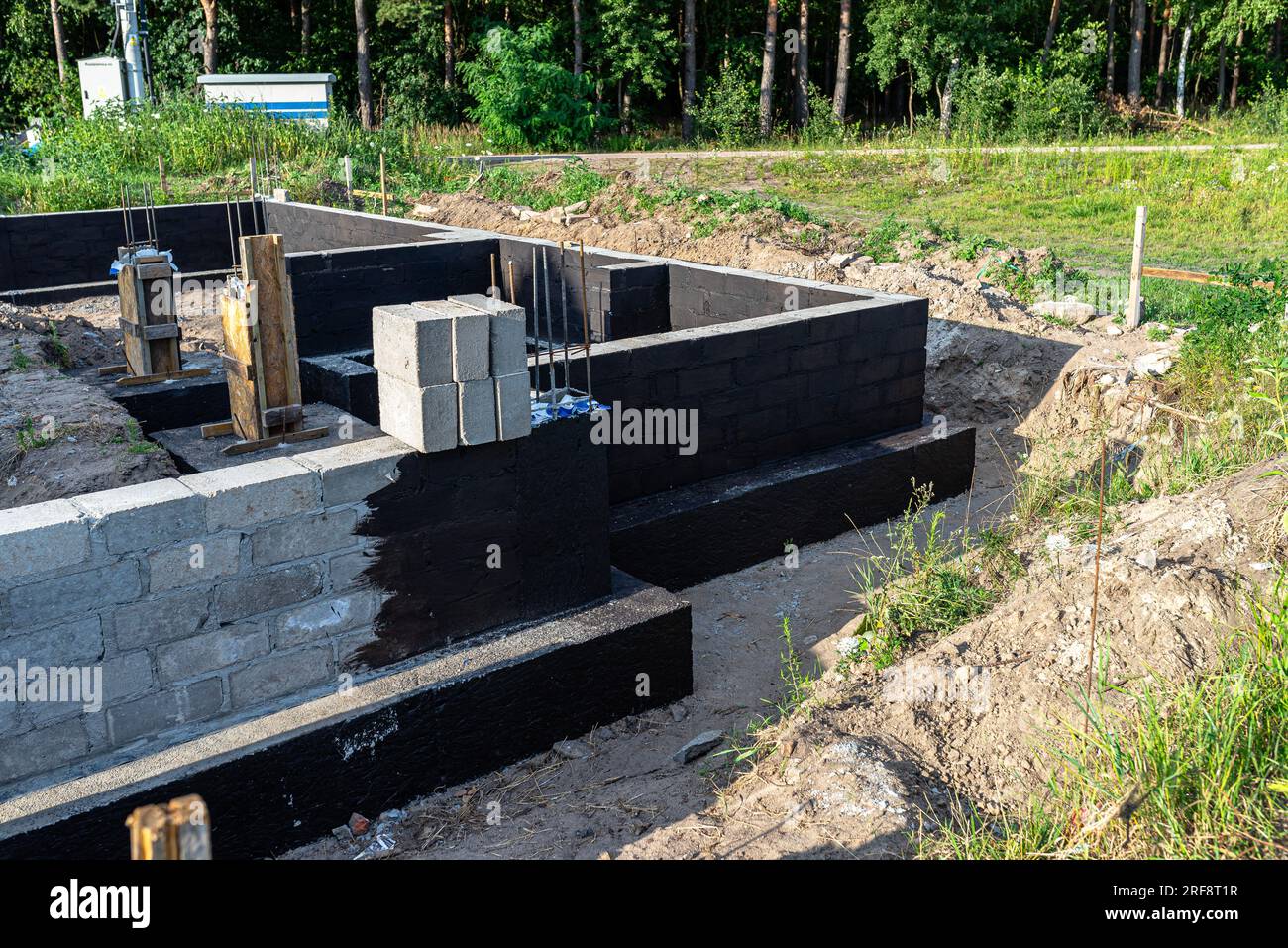 Footings made of concrete blocks painted with black dispersion asphalt ...