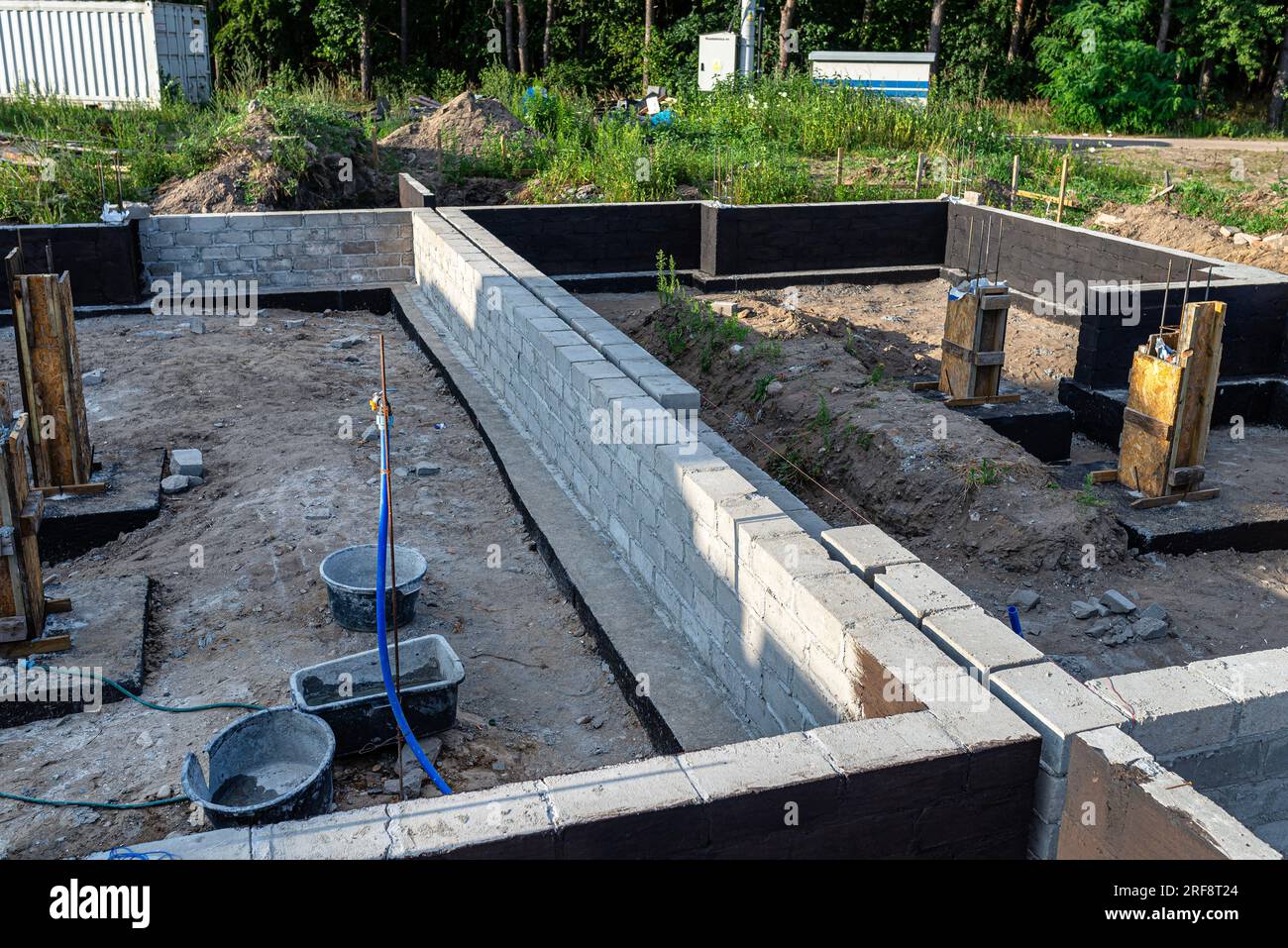 Footings made of concrete blocks painted with black dispersion asphalt ...