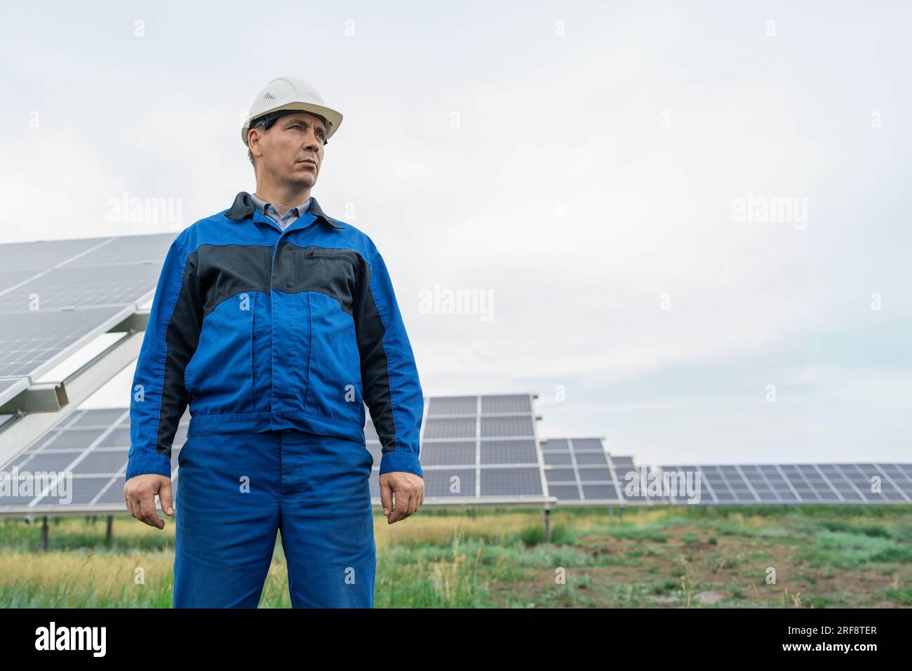 Service Engineer man standing in front of solar panels. Technician ...