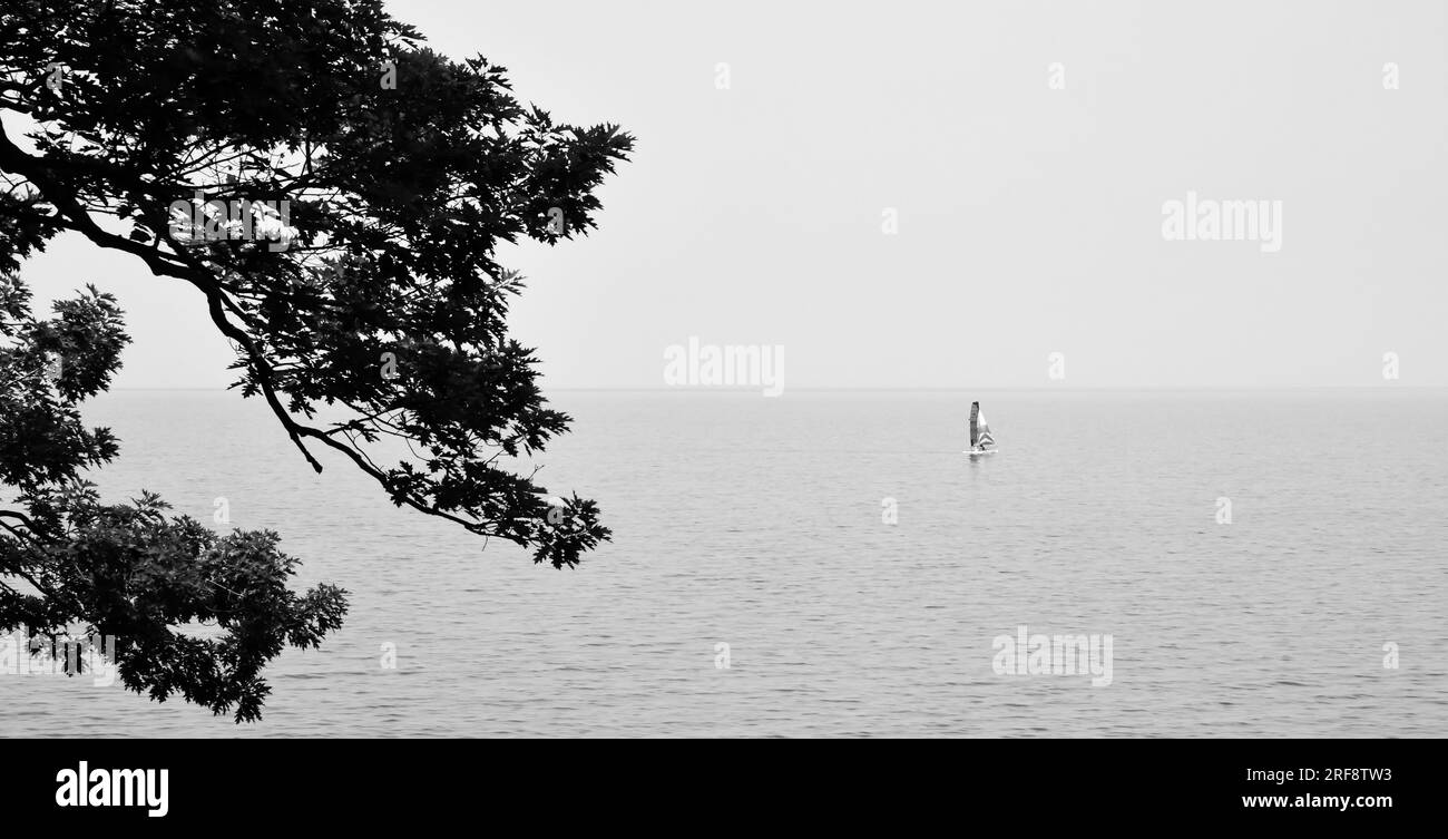 Single sailboat sailing across Lake Erie on a summer afternoon Stock ...