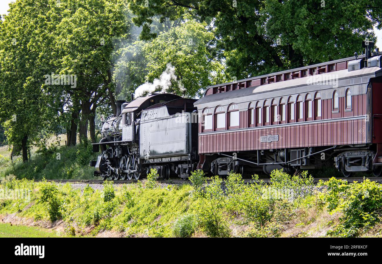 A Low Side, Behind View of A Steam Passenger Train Passing, Blowing ...