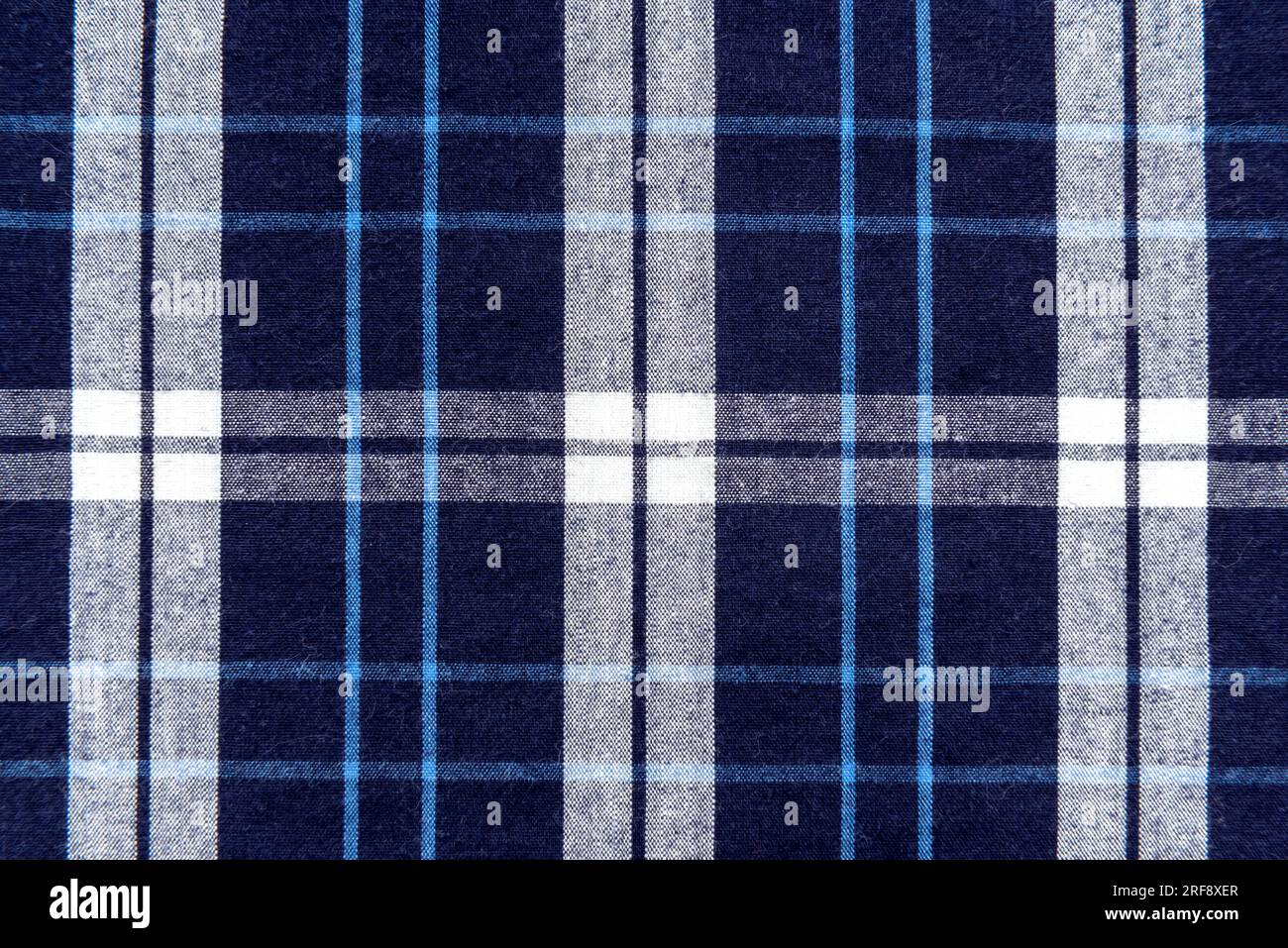 The texture of linen fabric in a large cell of blue and white. Scottish ...