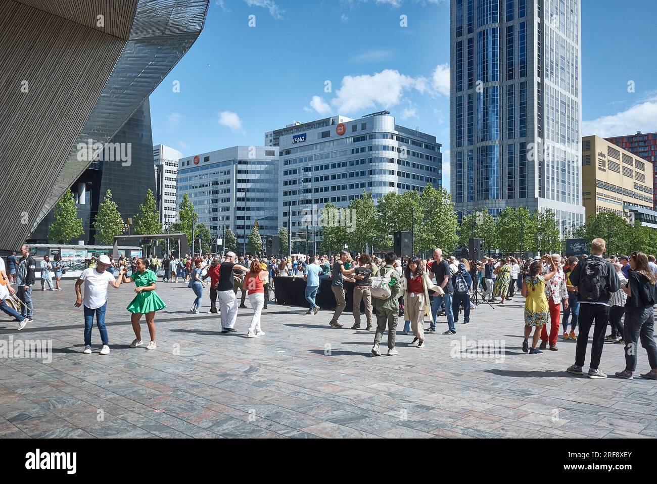 Saturday afternoon people are dancing on the huge place in front of the ...