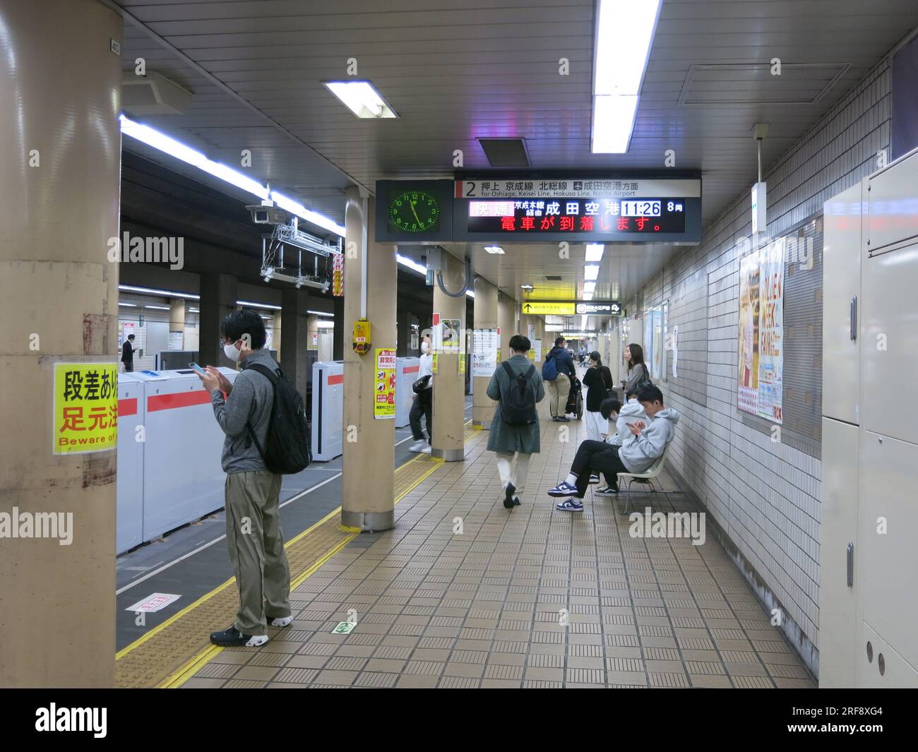 View of a platform and passengers waiting for a train on the Tokyo ...