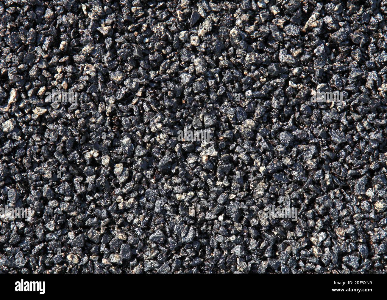 New asphalt surface, background. Detailed texture of fresh bitumen ...