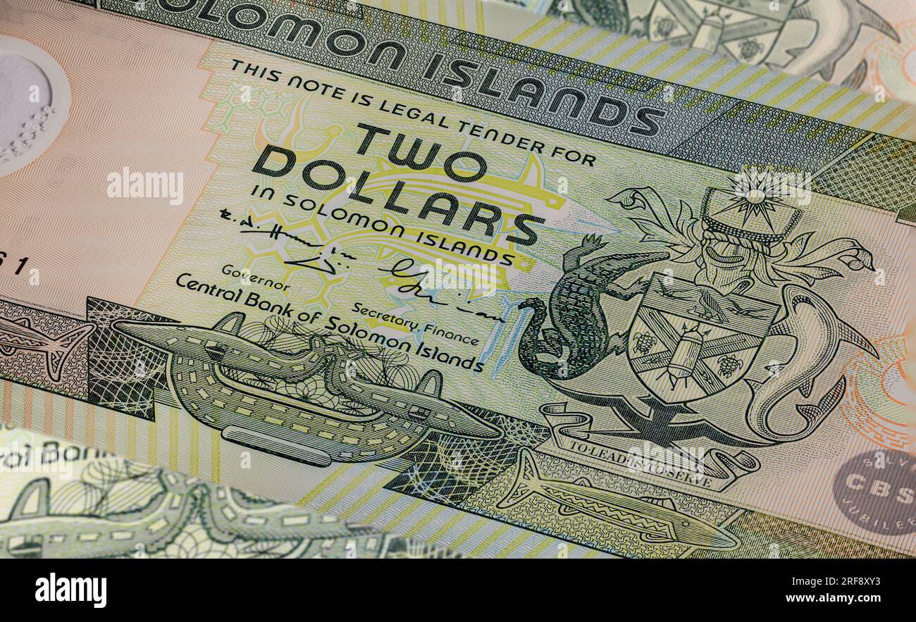 The 2 dollar note of the Solomon Islands features intricate artwork and ...