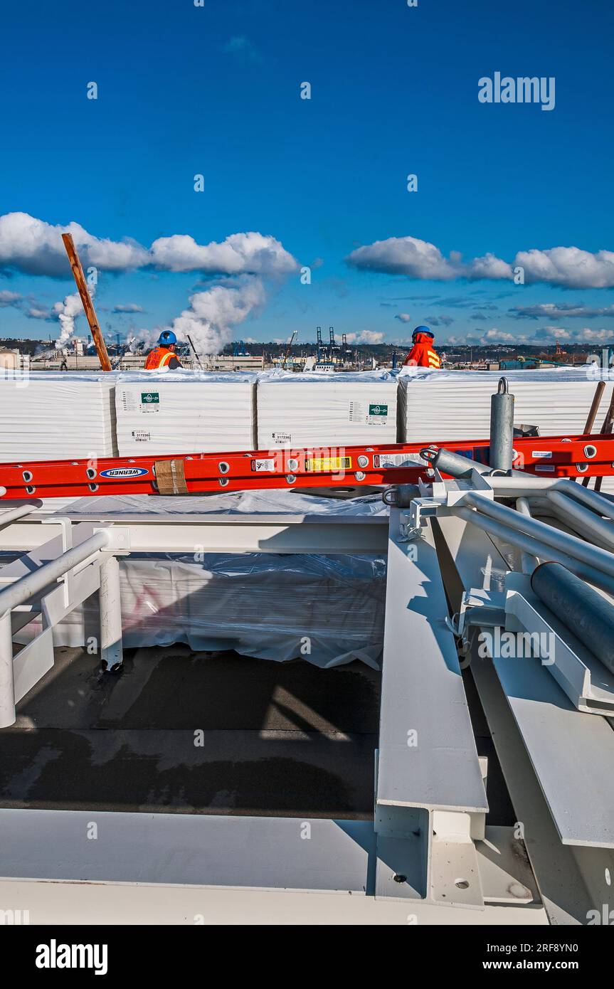 Construction workers on roof of new building still under construction ...