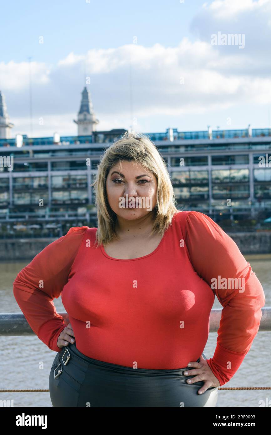 Vertical portrait of young plus size Hispanic Latina woman of ...