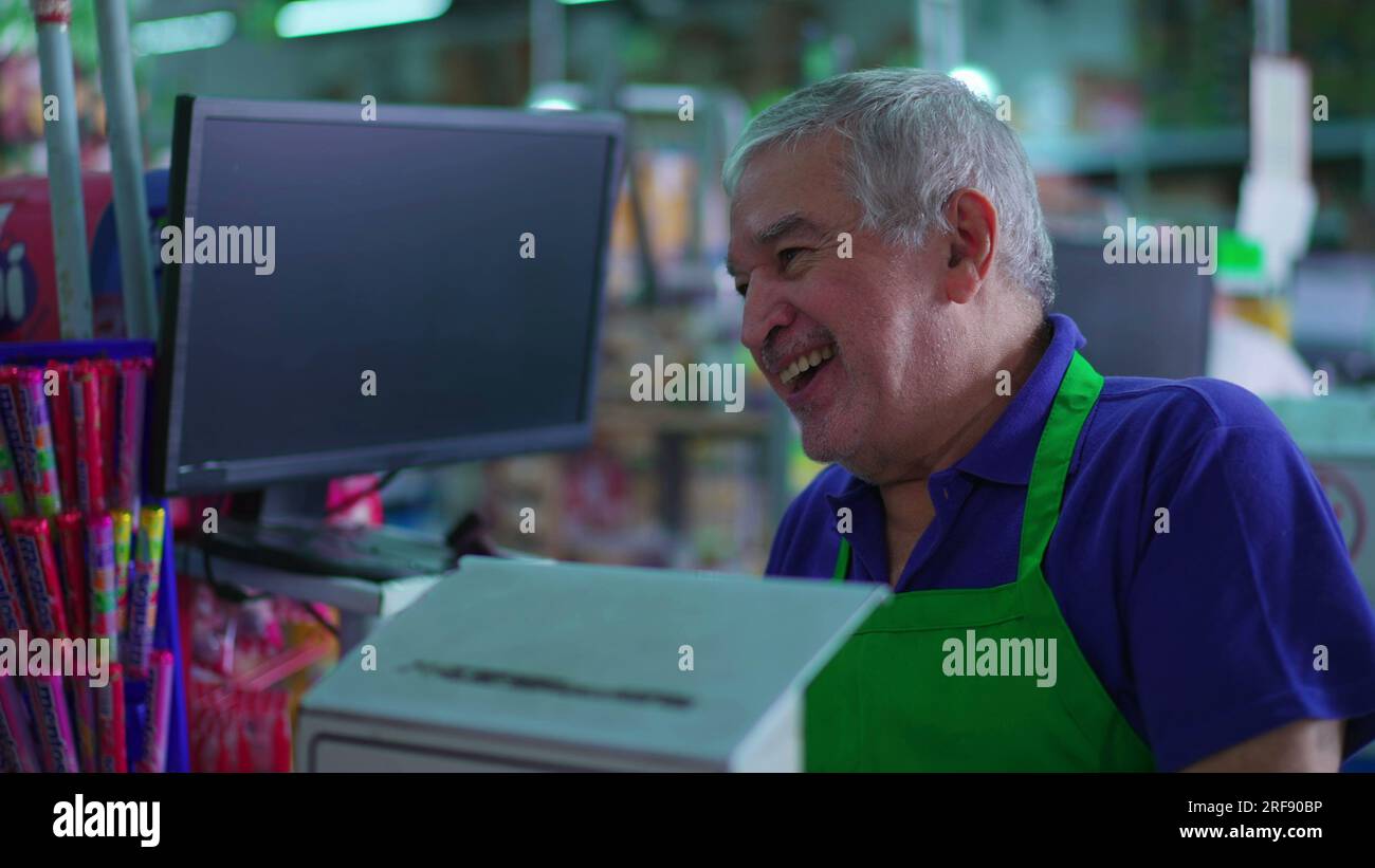 Female customer arriving at cashier checkout with smiling senior ...