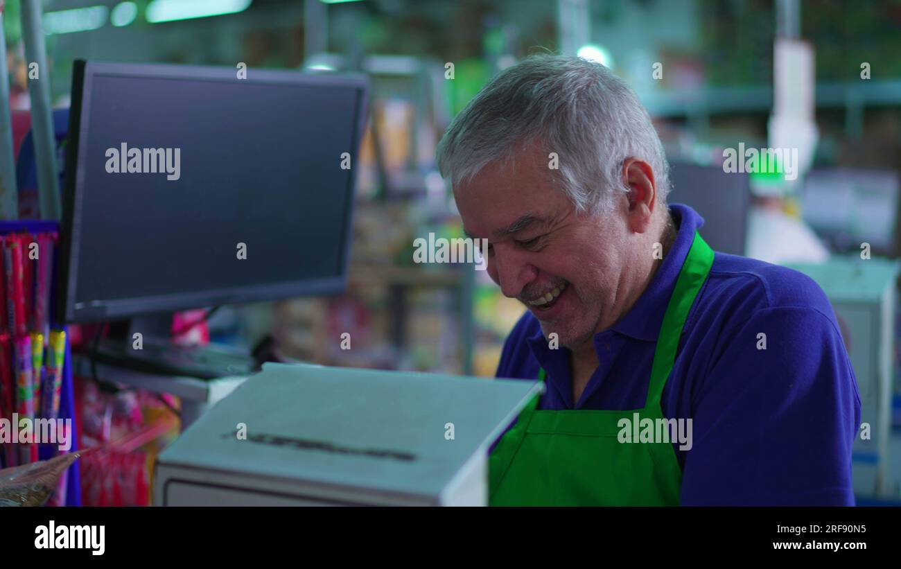 Female customer arriving at cashier checkout with smiling senior ...