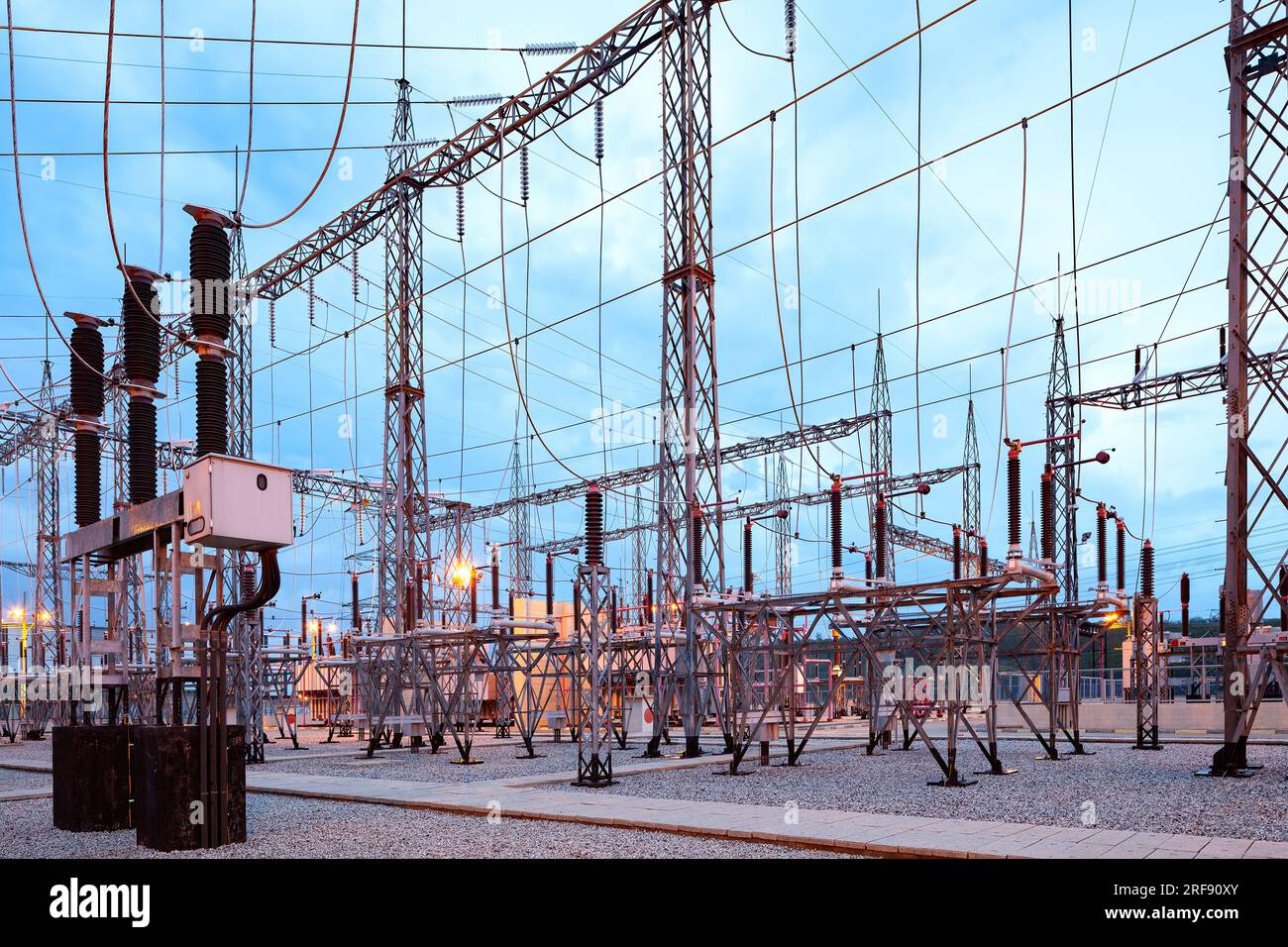 Illuminated electricity substation at dusk Stock Photo - Alamy