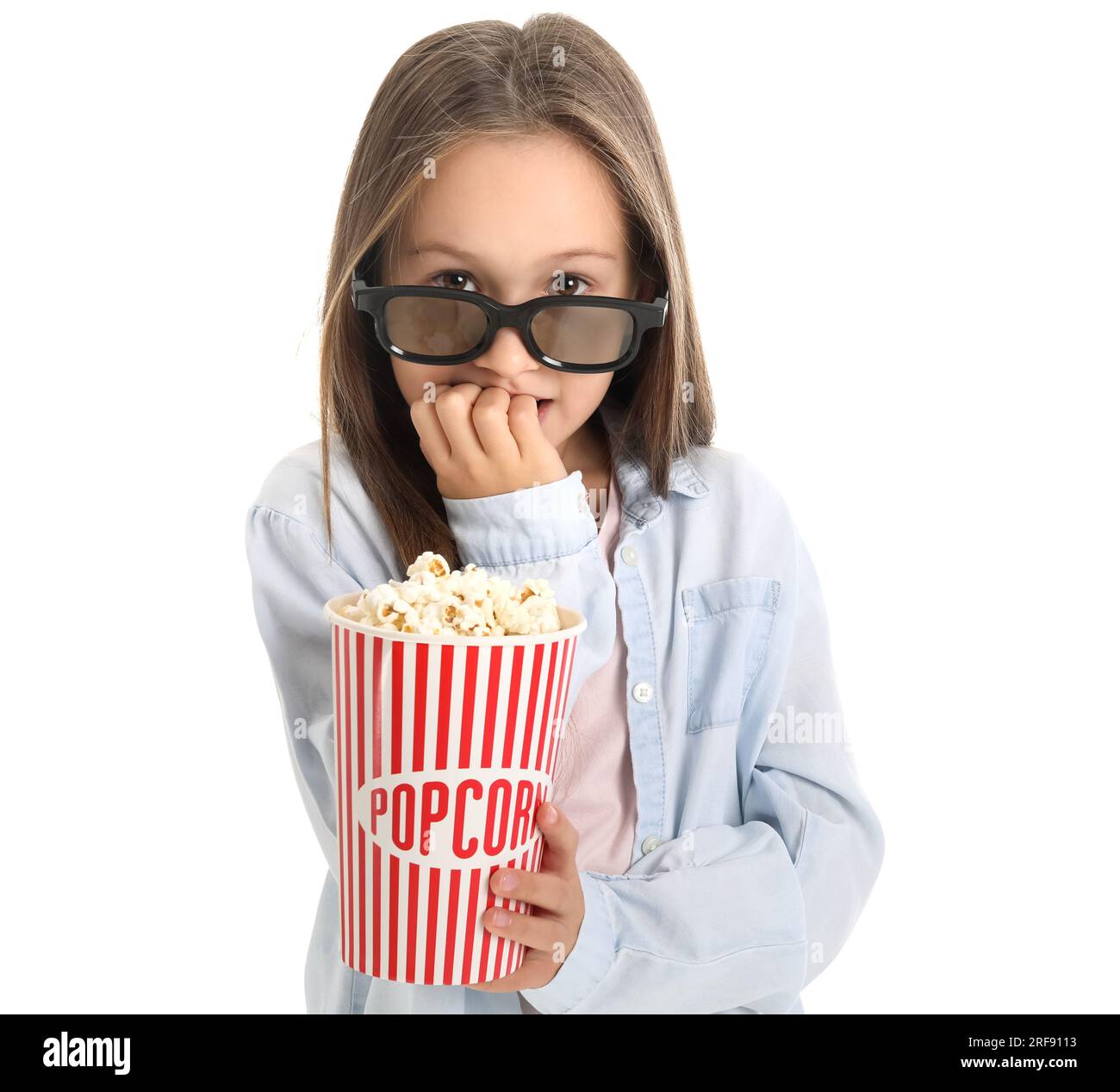 Little girl in 3D glasses with popcorn biting nails on white background ...