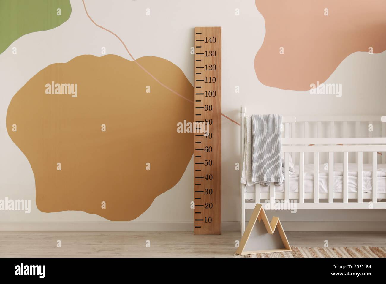 Interior of children's bedroom with bed and stadiometer Stock Photo - Alamy