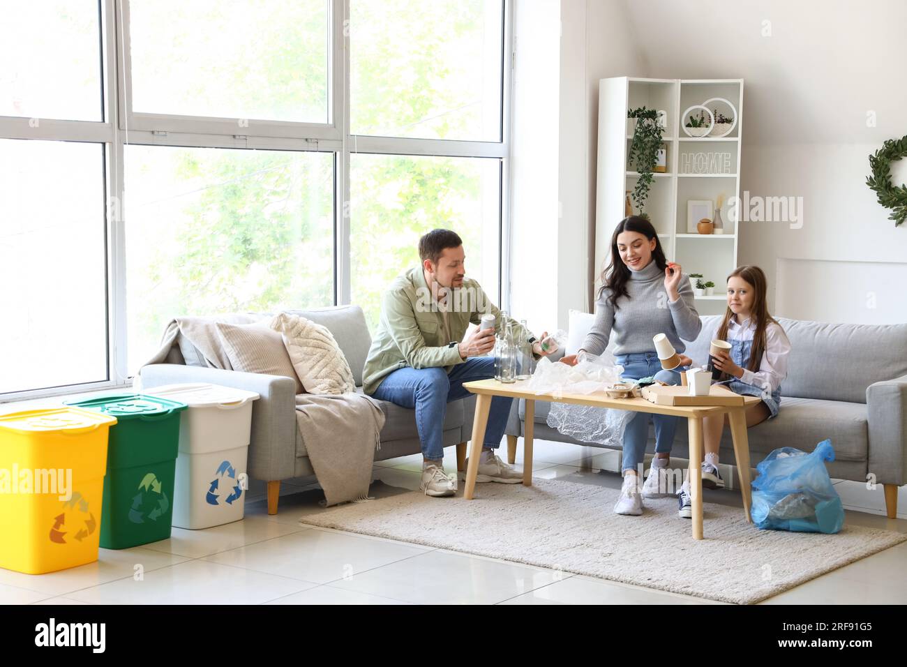 Family sorting garbage at home Stock Photo - Alamy