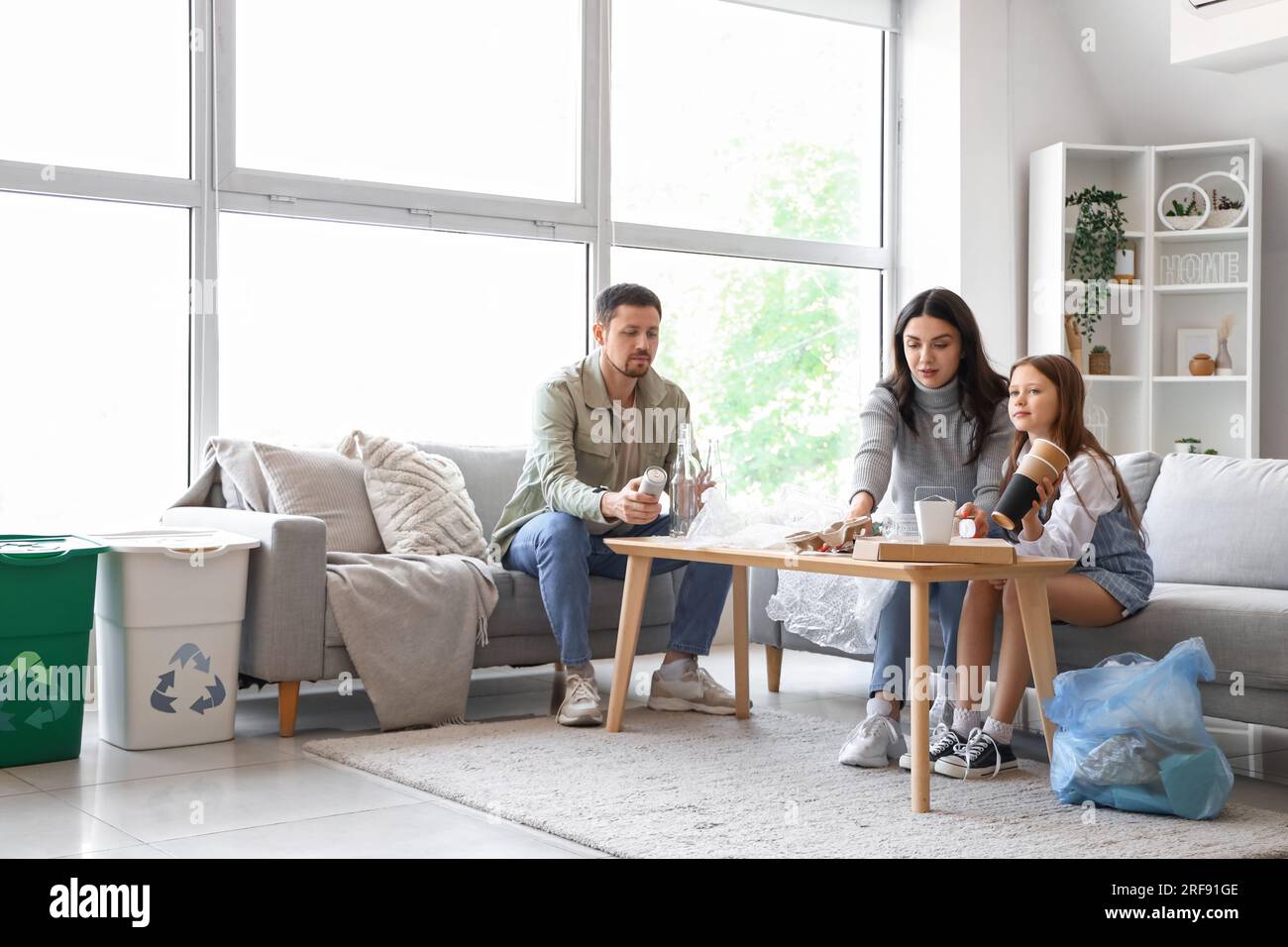 Family sorting garbage at home Stock Photo - Alamy