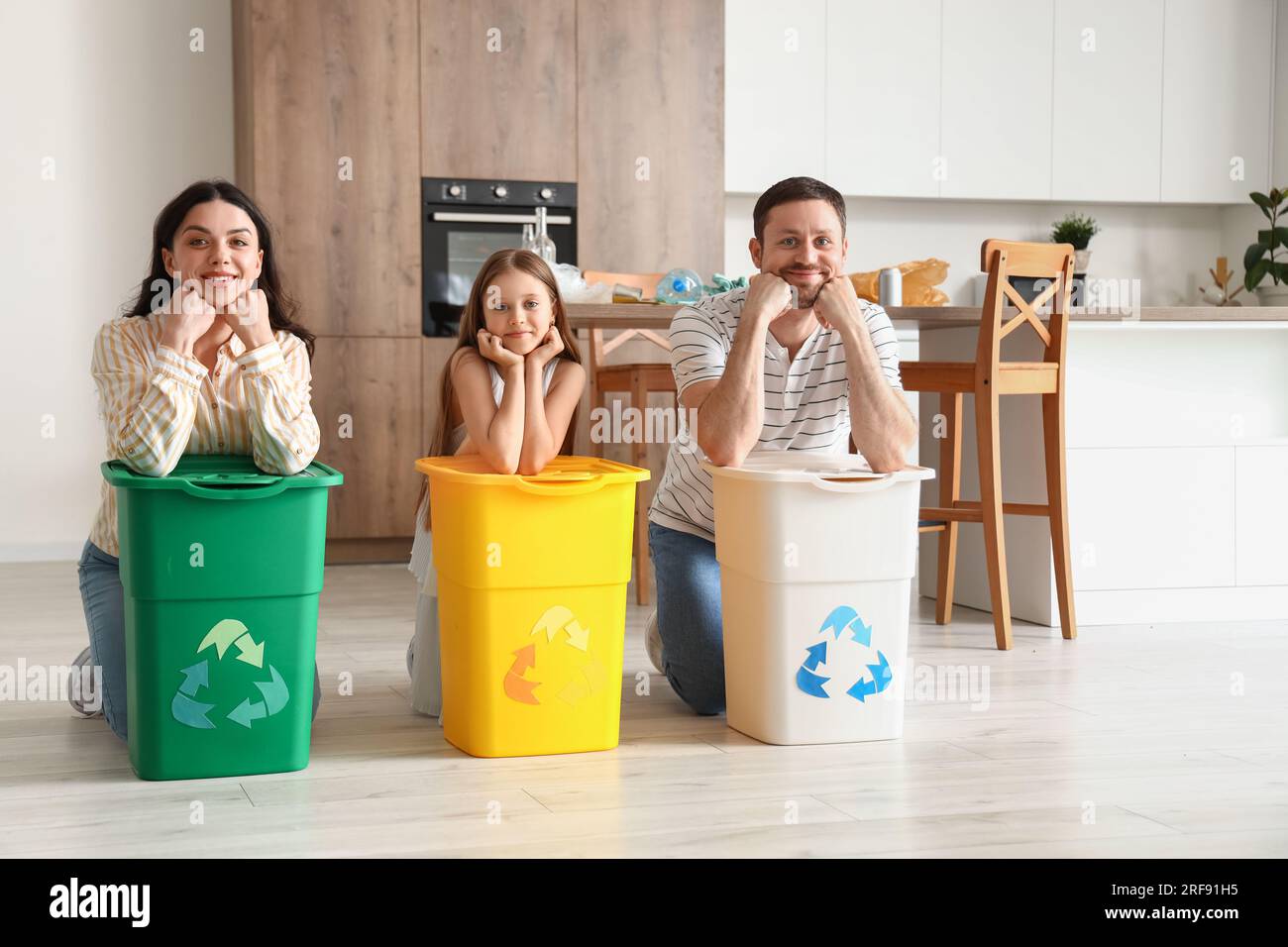 Family with recycle trash bins in kitchen Stock Photo - Alamy