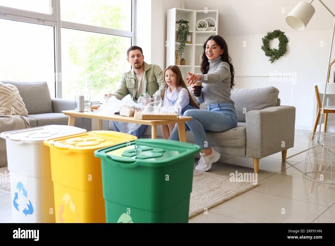 Family sorting garbage at home Stock Photo - Alamy