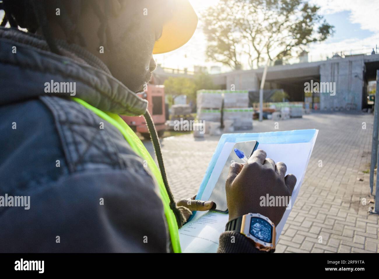 rear view of black engineer man of african ethnicity wearing yellow ...