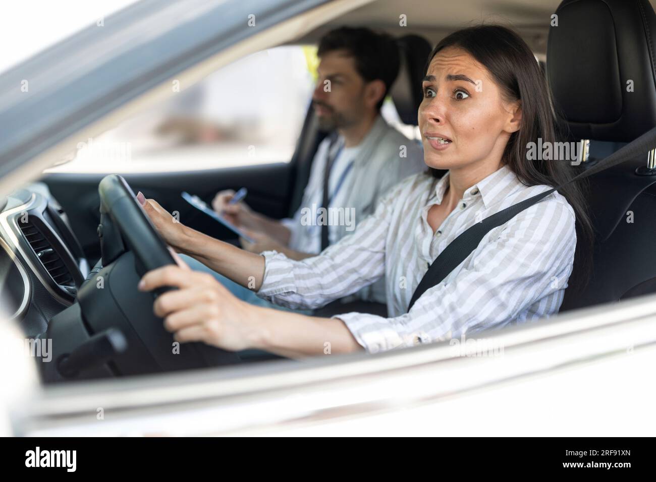Scared unconfident woman driving car with instructor by her side Stock ...