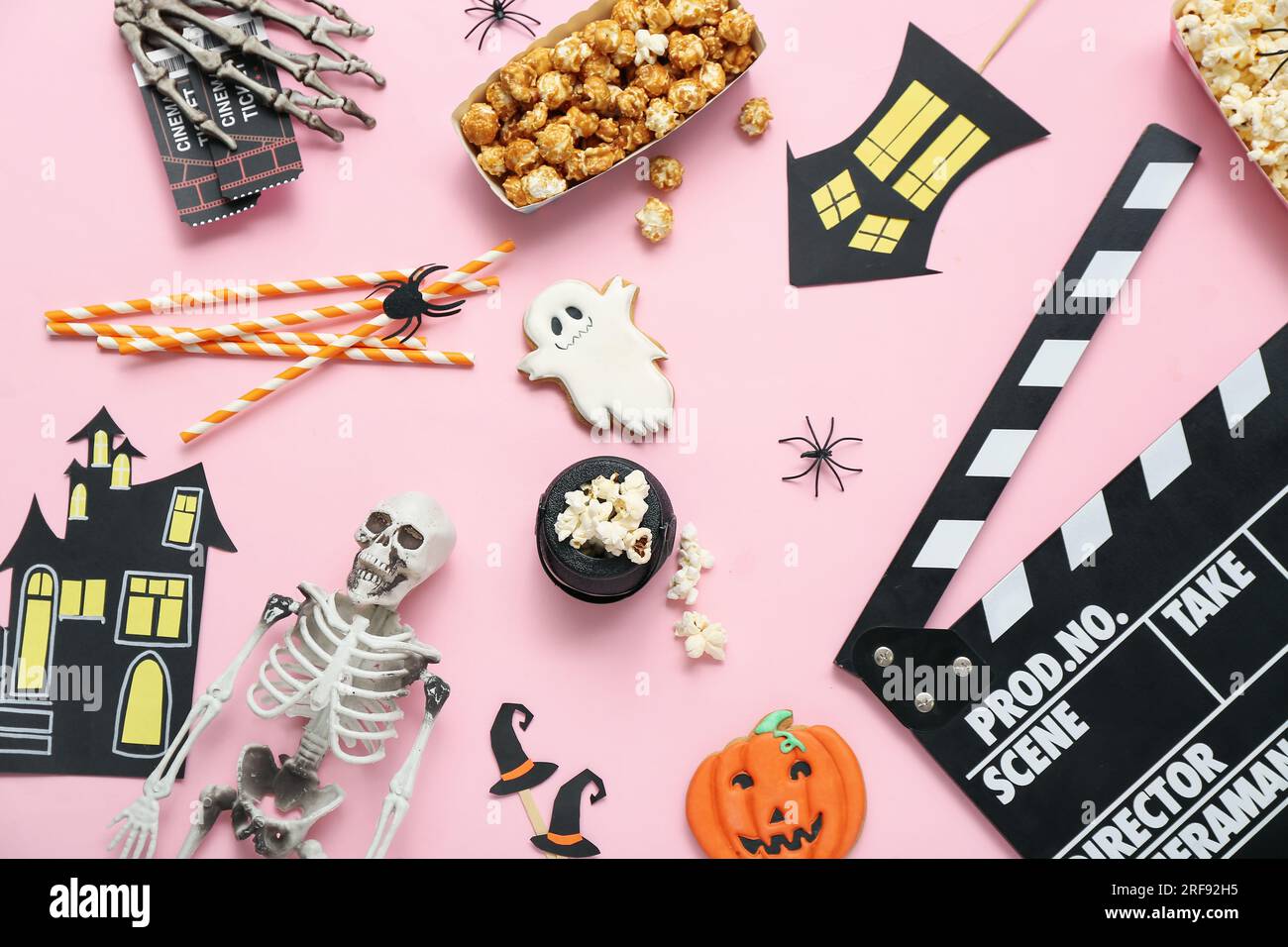 Composition with tasty popcorn, skeleton and clapperboard on pink ...