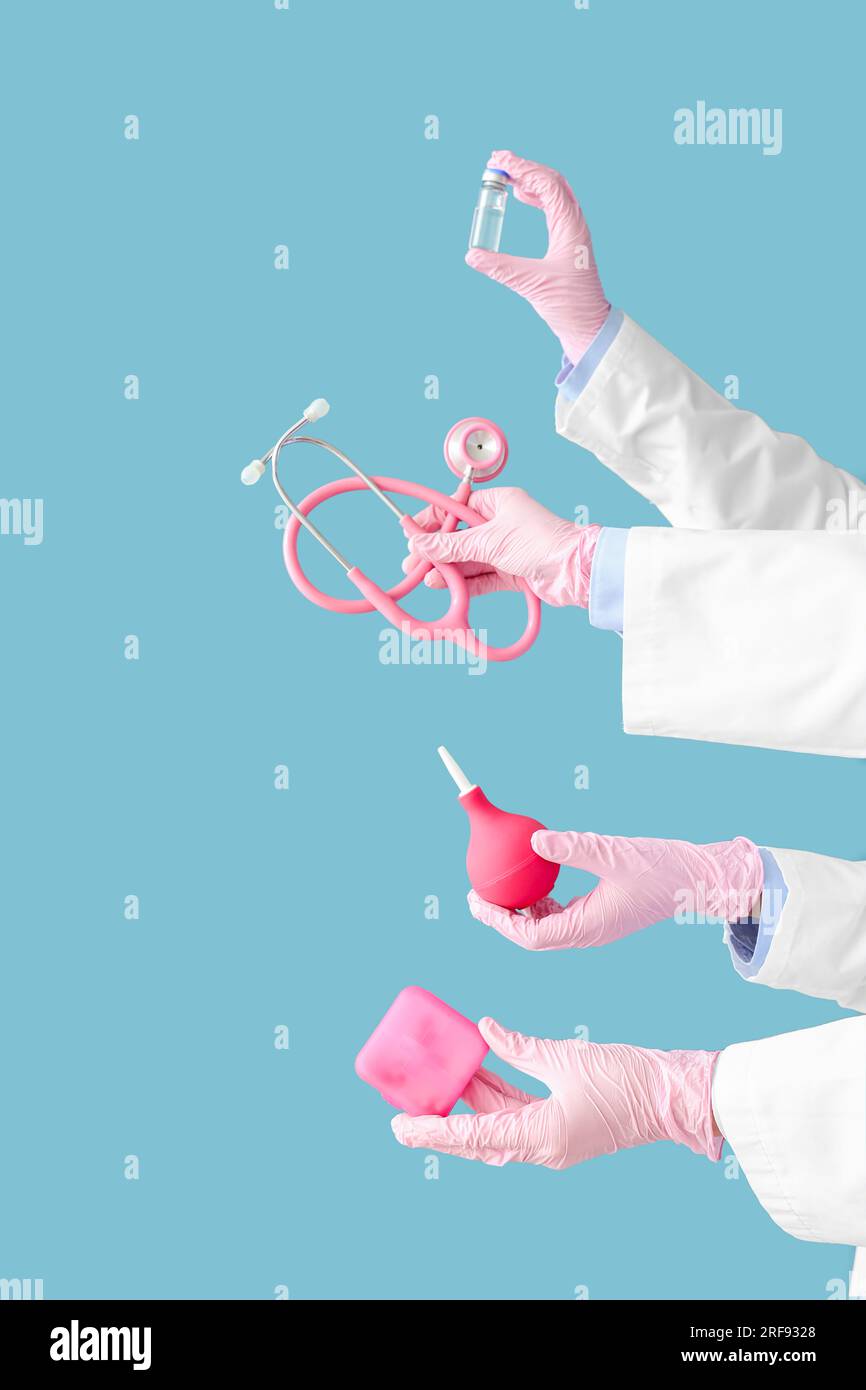 Female doctor's hands with different medical tools on blue background ...