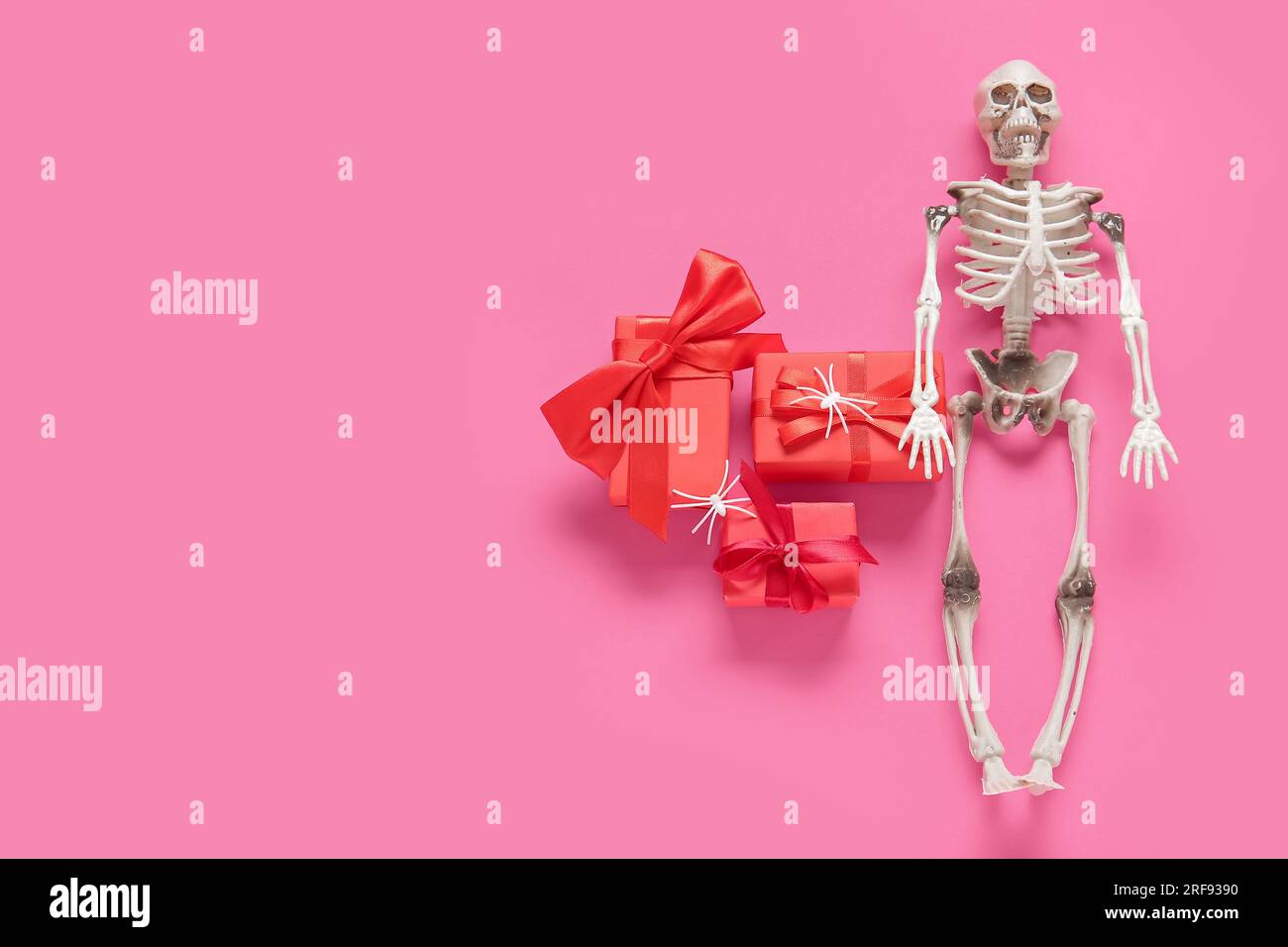 Composition with beautiful gift boxes and skeleton for Halloween on ...