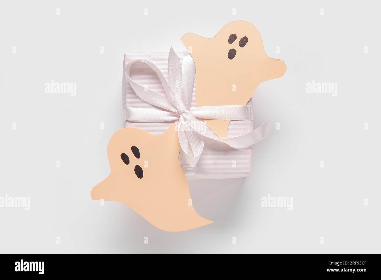 Beautiful gift box and ghosts made of paper for Halloween on white ...