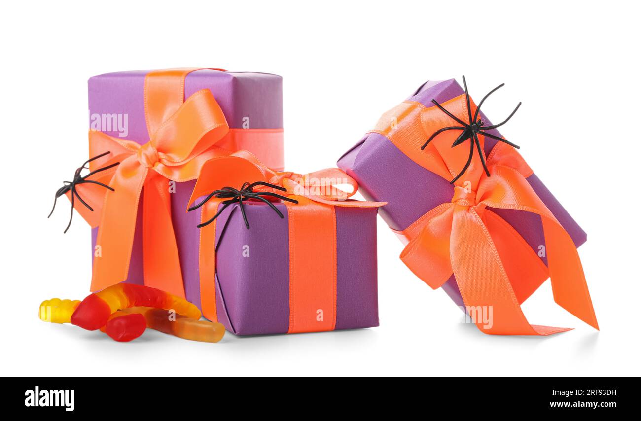 Spiders, tasty candies and gift boxes for Halloween on white background ...