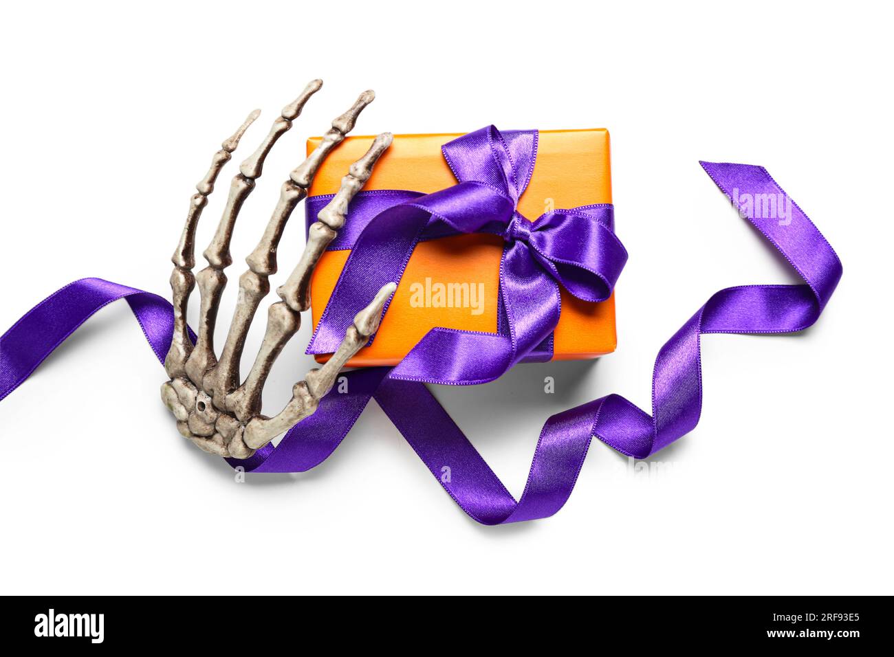 Skeleton hand and gift box for Halloween on white background Stock ...