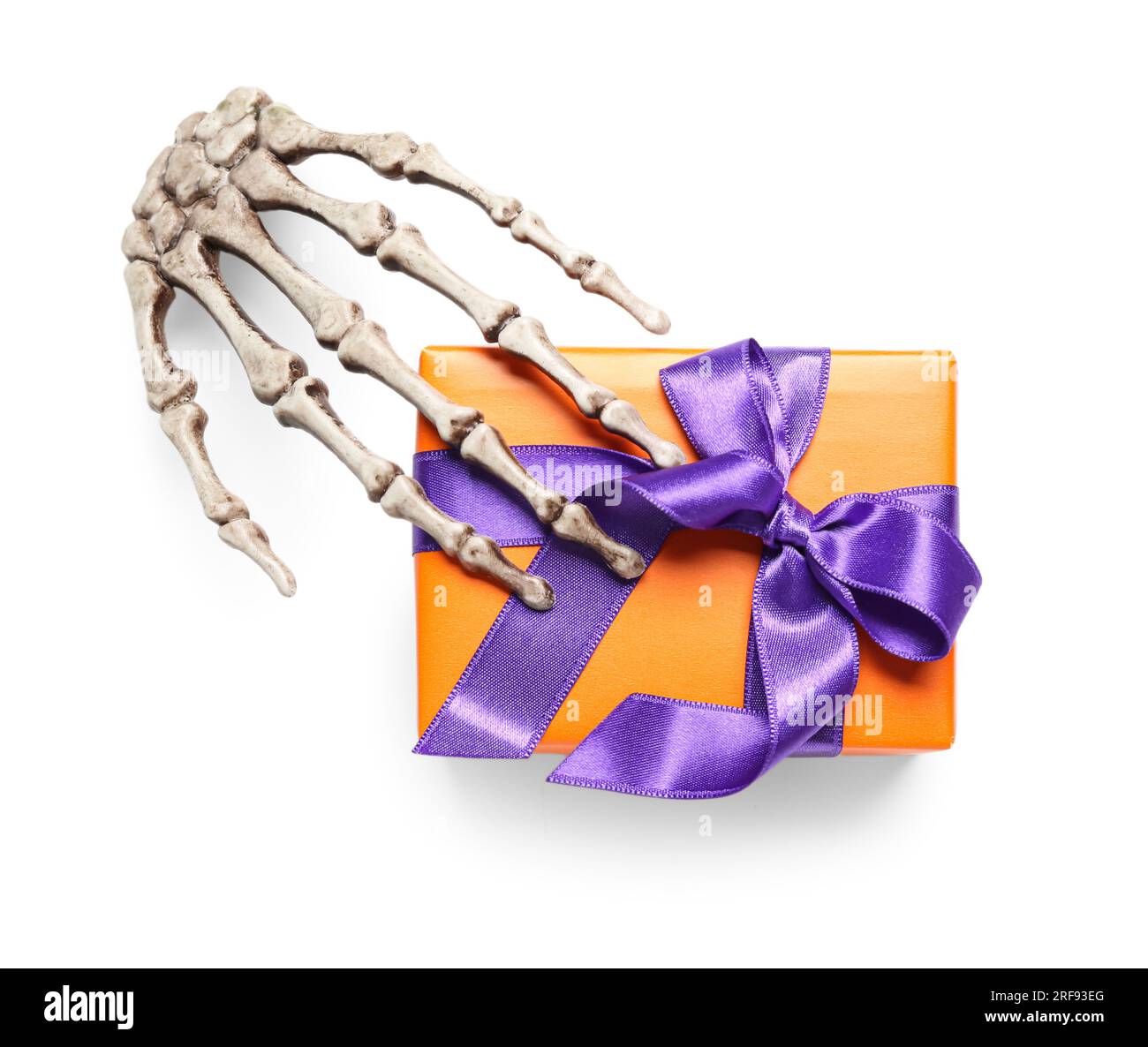 Skeleton hand and gift box for Halloween on white background Stock ...