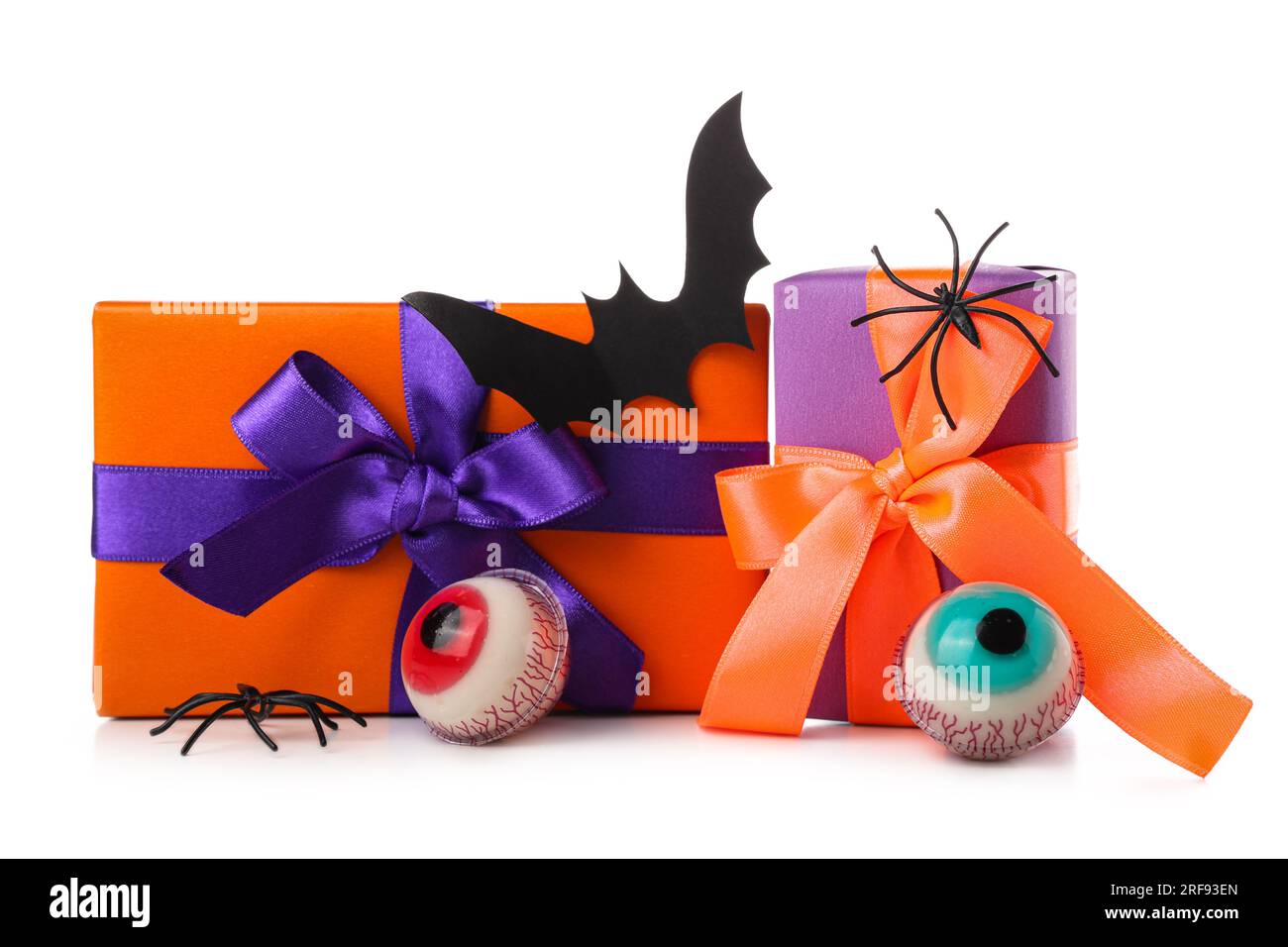 Tasty candies, spiders and gift boxes for Halloween on white background ...