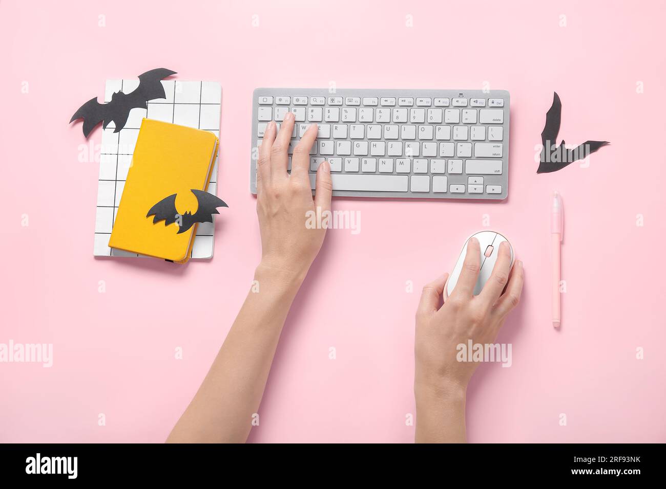 Female hands with modern computer keyboard, mouse, notebooks and paper ...