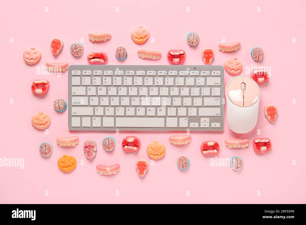 Composition with modern computer keyboard and different tasty candies ...