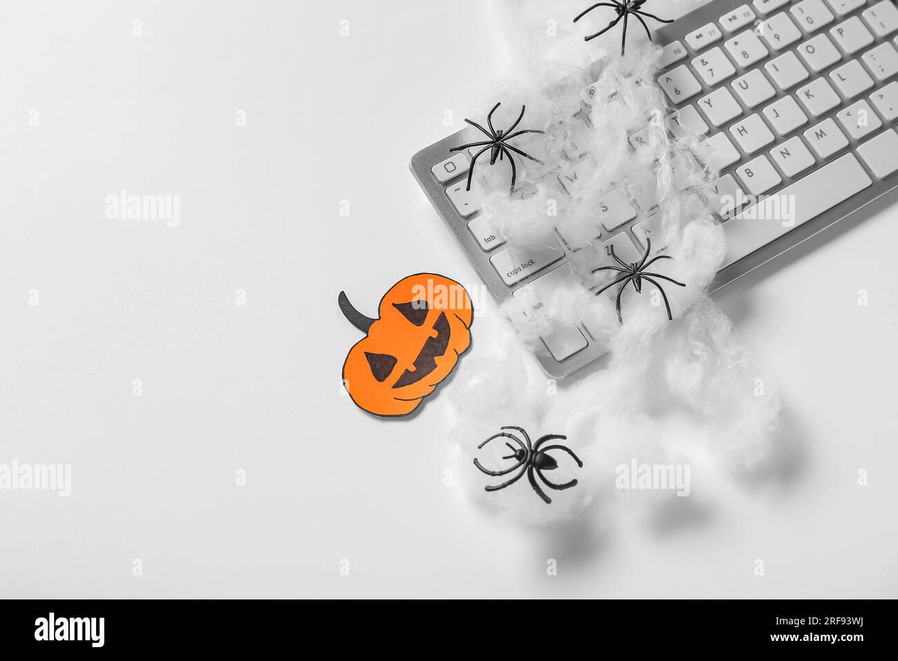 Modern computer keyboard, web and spiders for Halloween on white ...