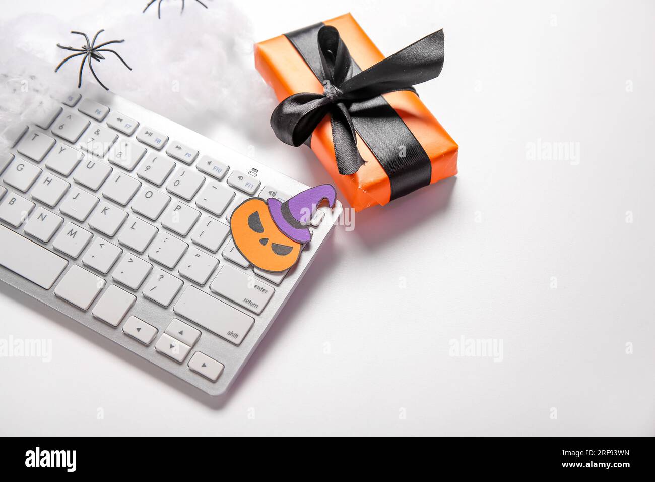 Modern computer keyboard, gift box, web and spiders for Halloween on ...