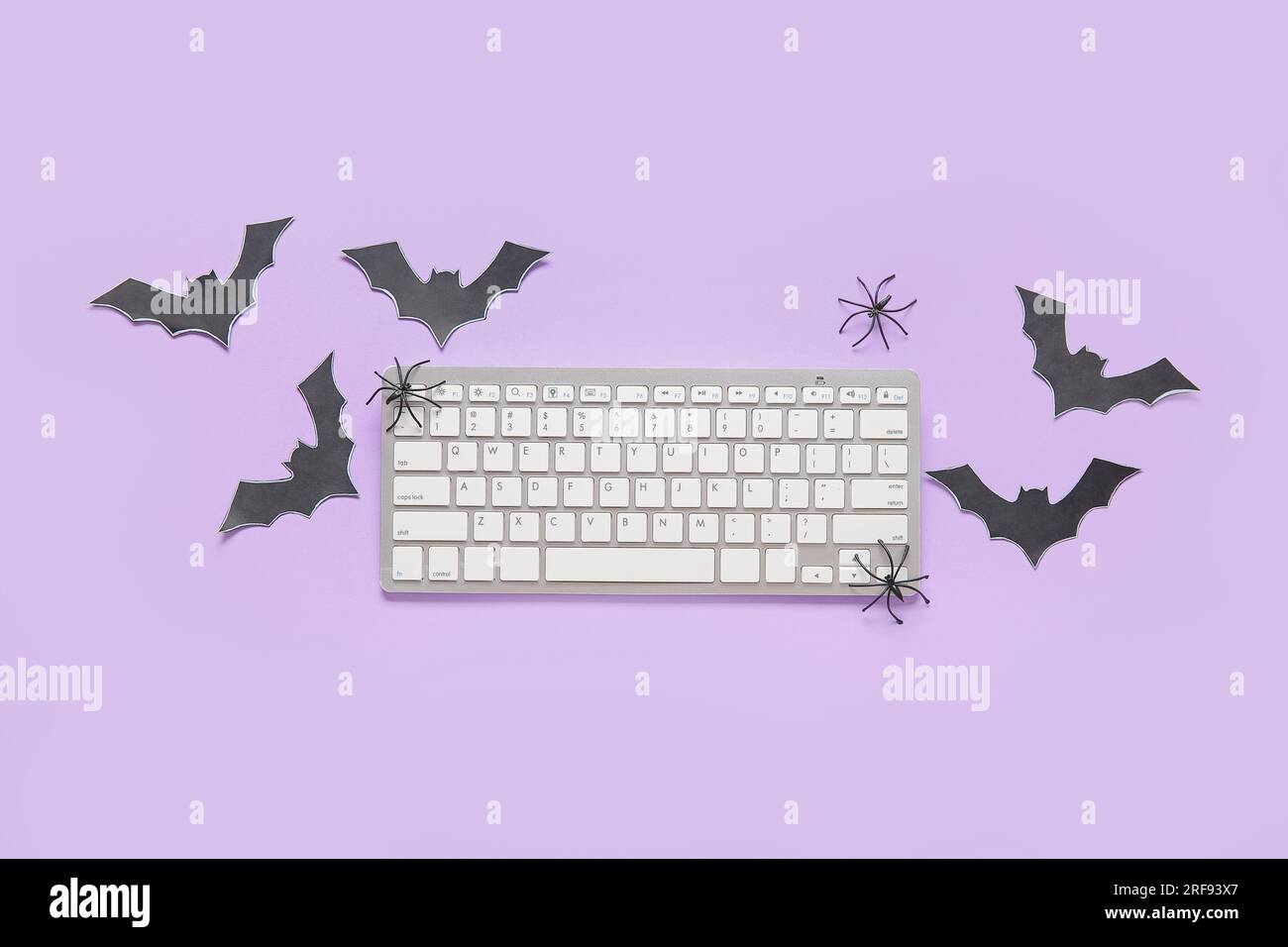 Composition with modern computer keyboard, spiders and paper bats for ...