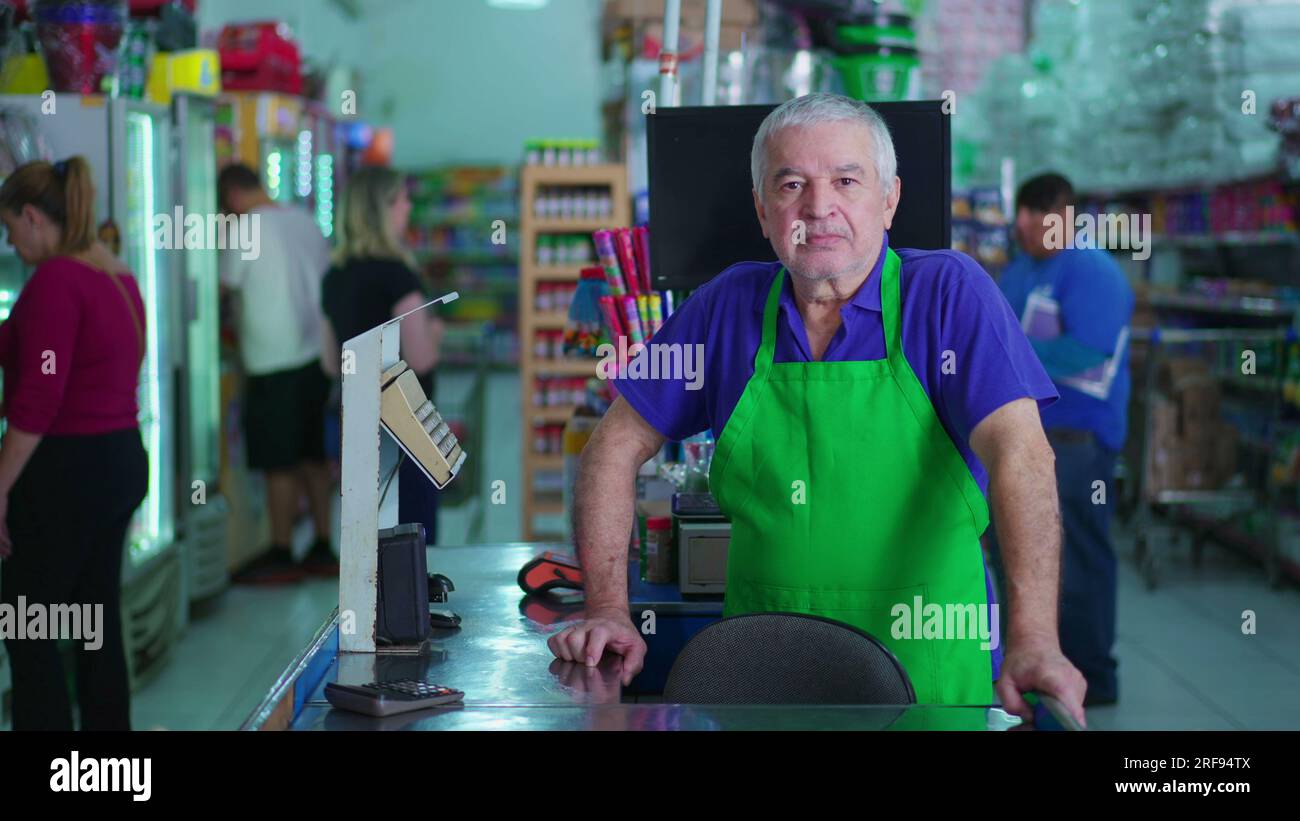 Senior employee supermarket standing cashier hi-res stock photography ...