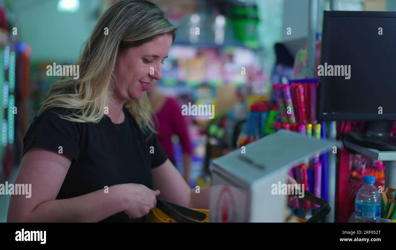Supermarket Scene of Female Customer Approaching Checkout, Welcomed by ...