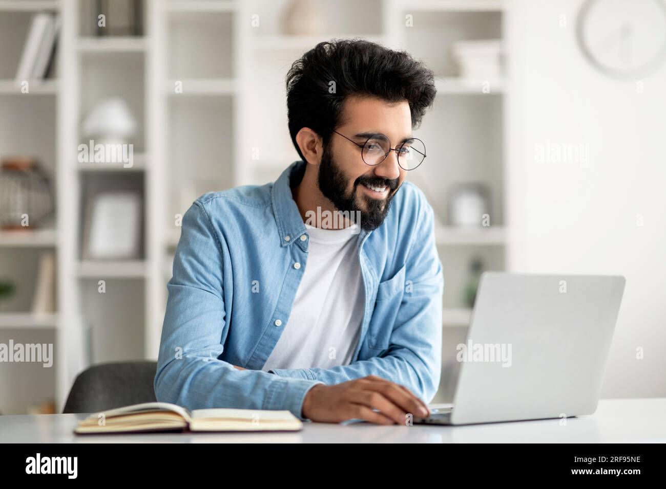 Networking Concept. Handsome Young Indian Guy Browsing Internet On ...