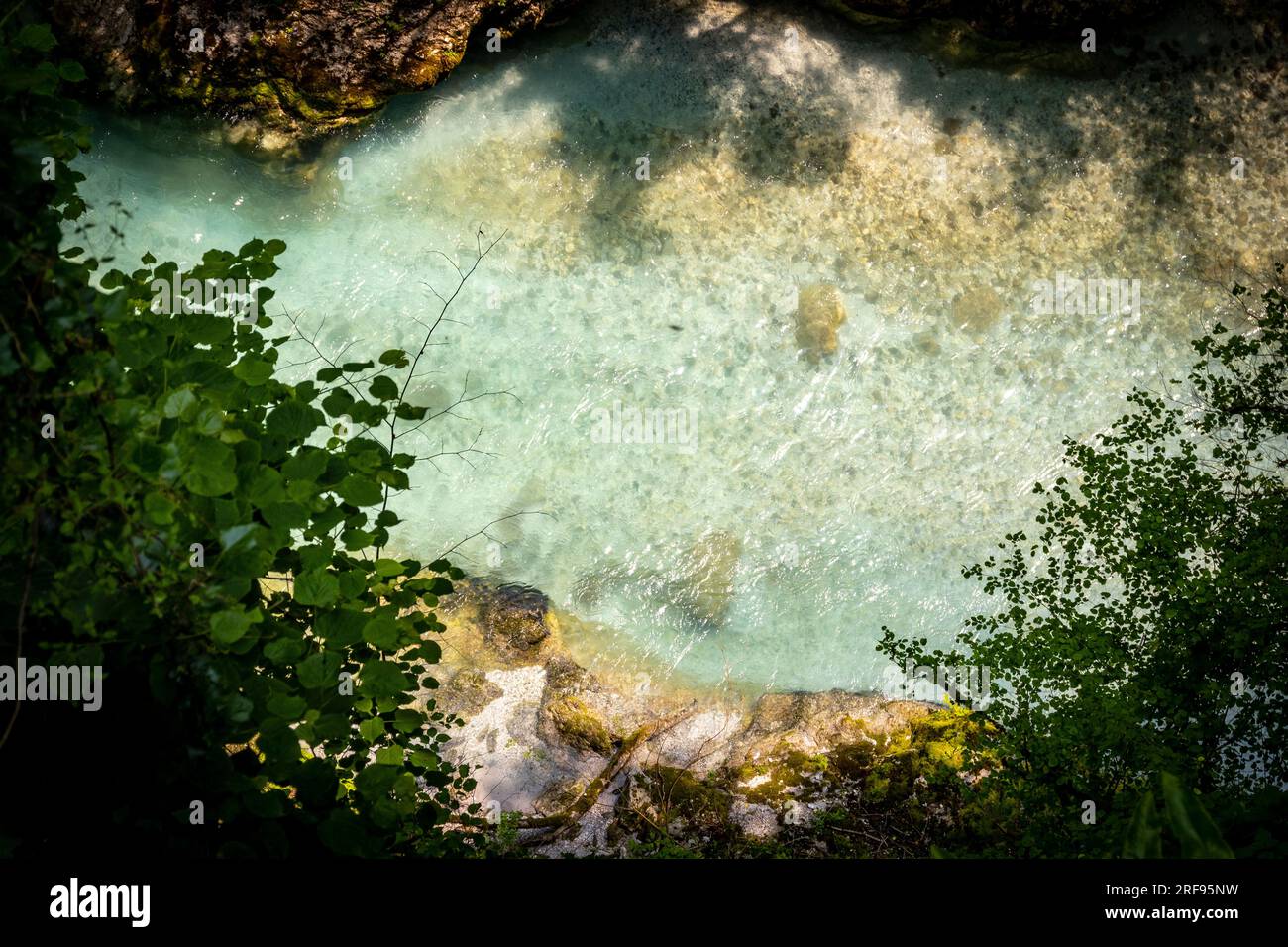 Top down view of crystal clear Alpine river Soca, passing through the ...