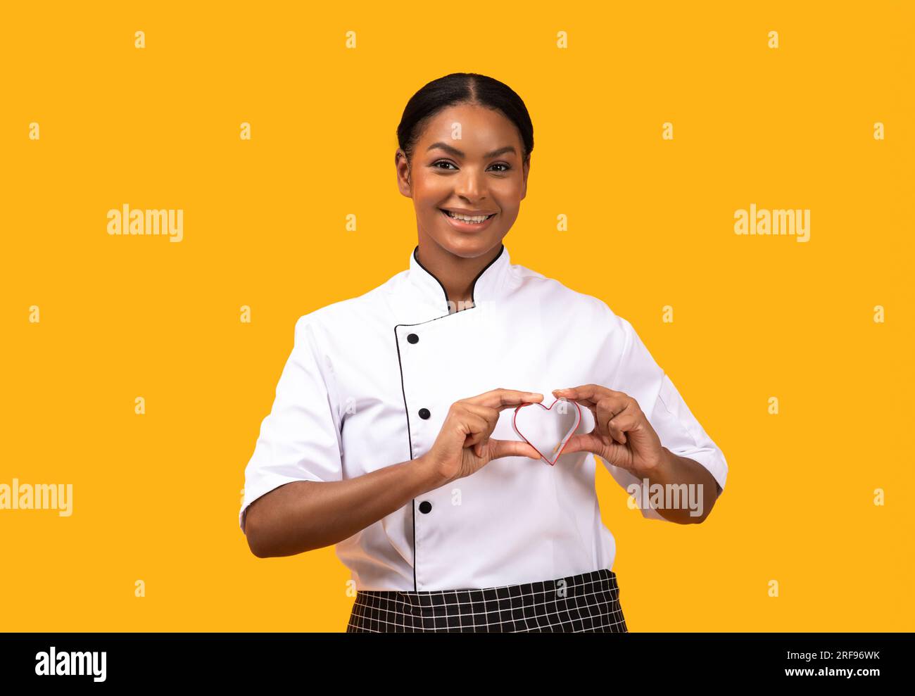 Smiling Black Female Chef Holding Heart-Shaped Cookie Mold Near Chest ...